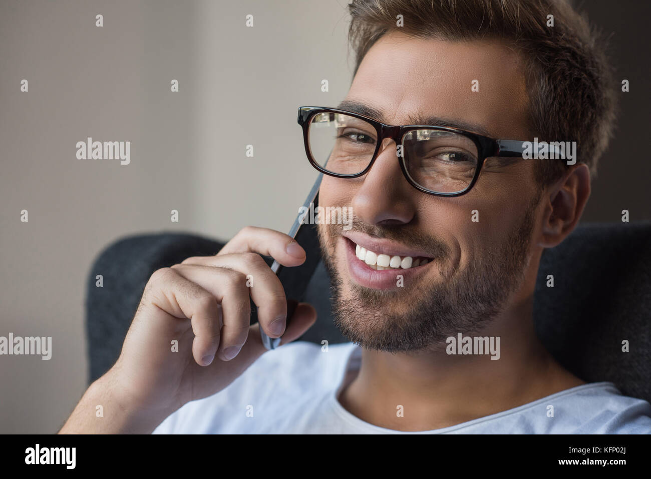 Smiling man talking on smartphone Stock Photo - Alamy