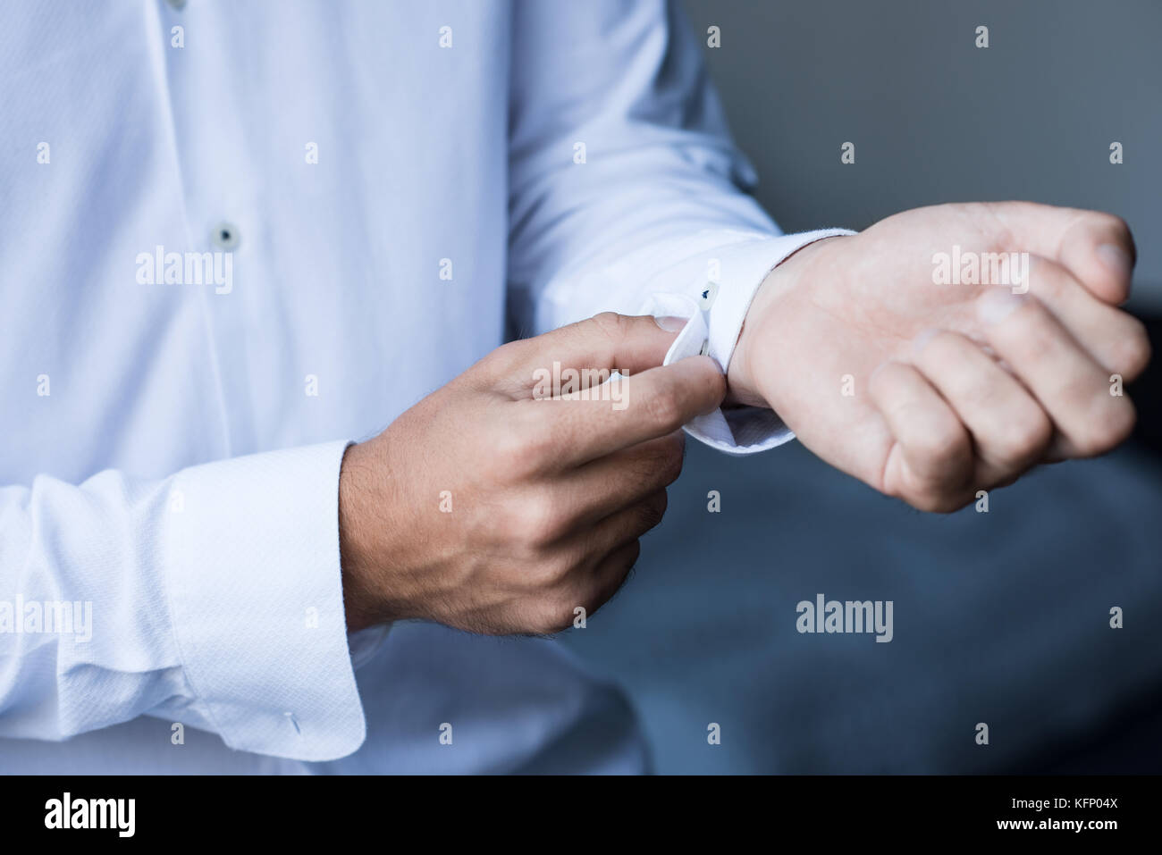 man buttoning up cuffs Stock Photo - Alamy