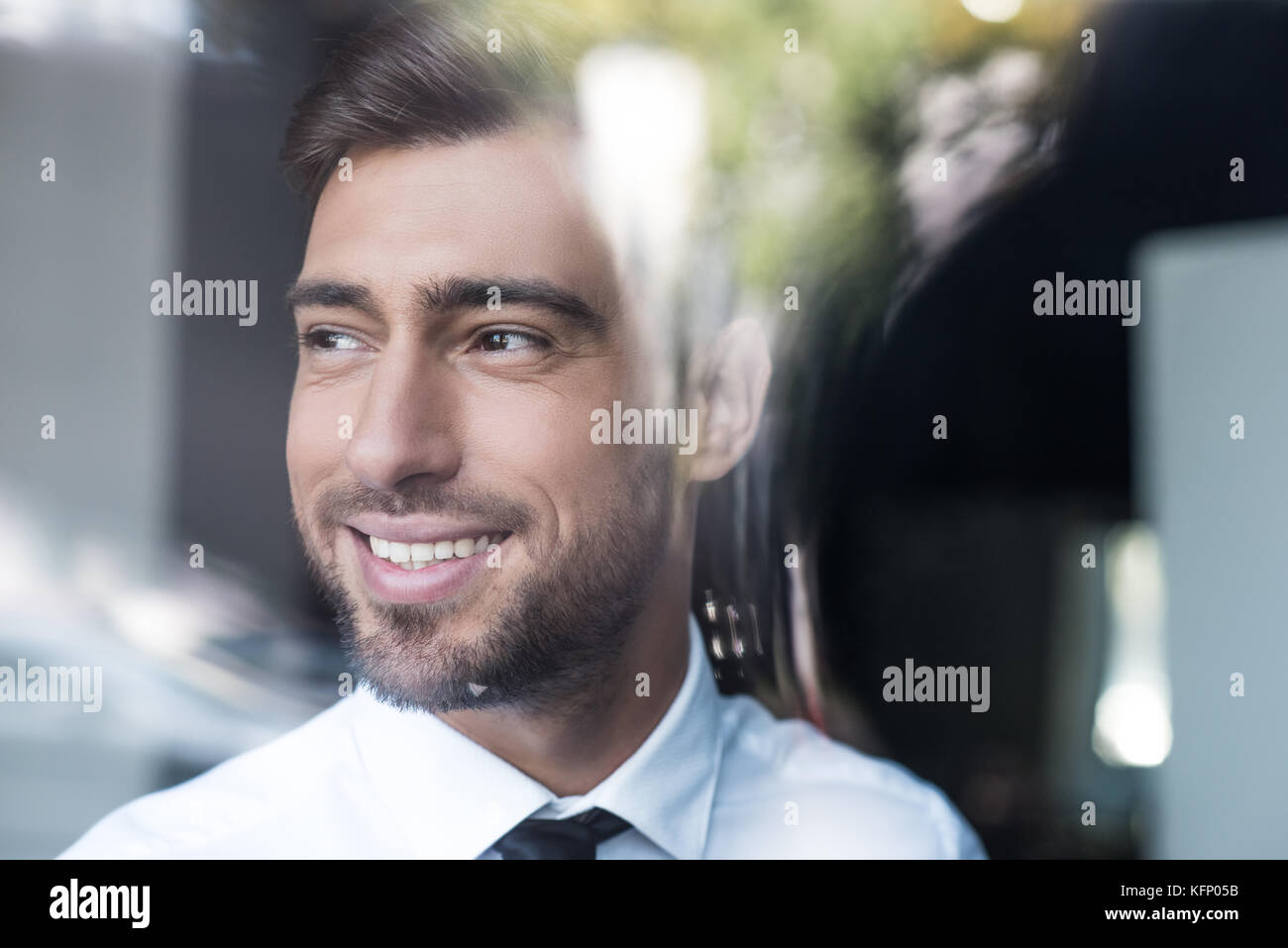 Smiling businessman looking out window Stock Photo - Alamy
