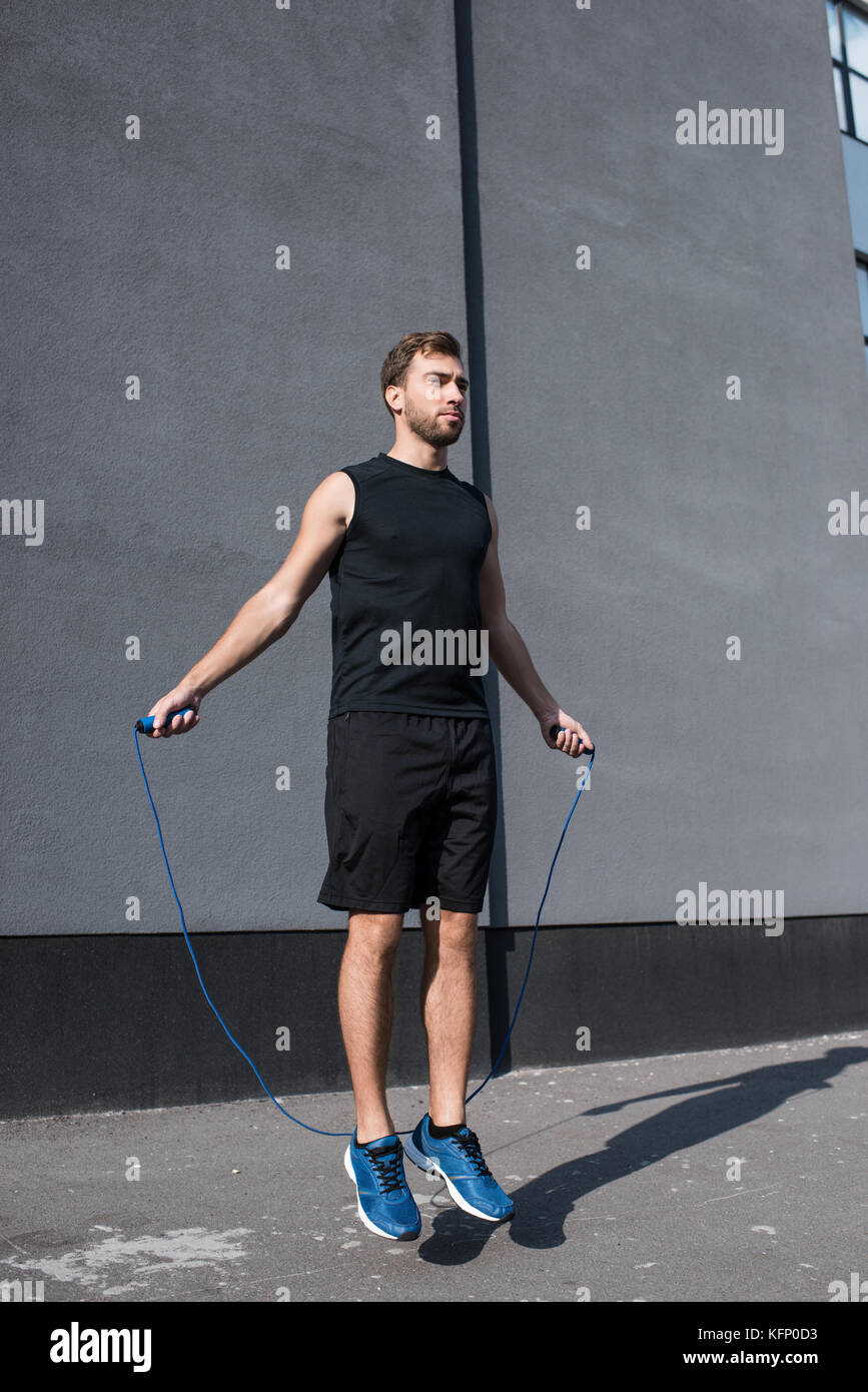 athletic sportsman jumping with rope Stock Photo - Alamy
