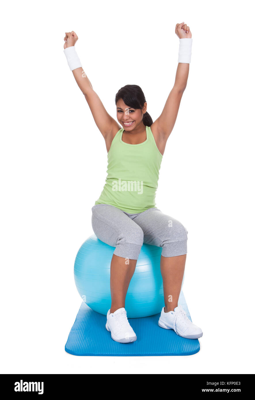 Woman Exercising On Fitness Ball Over White Background Stock Photo - Alamy