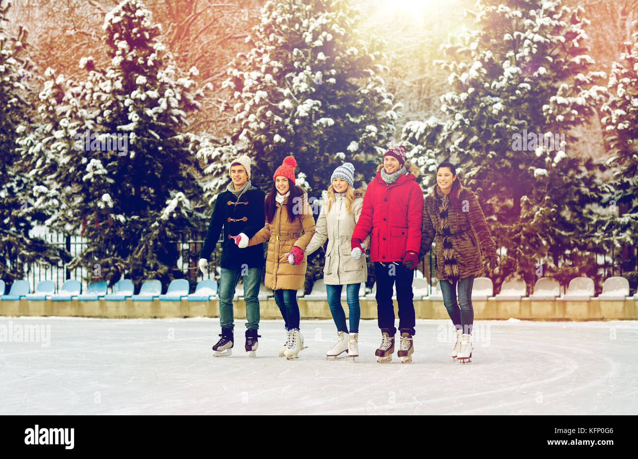 happy friends ice skating on rink outdoors Stock Photo - Alamy