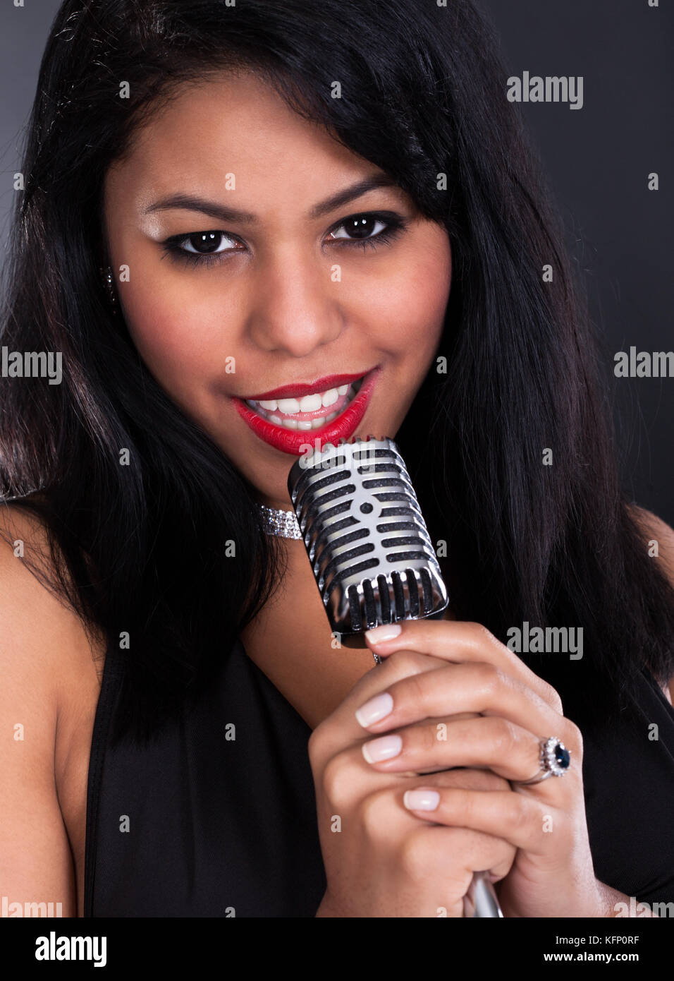 Pretty black woman microphone singing hi-res stock photography and ...