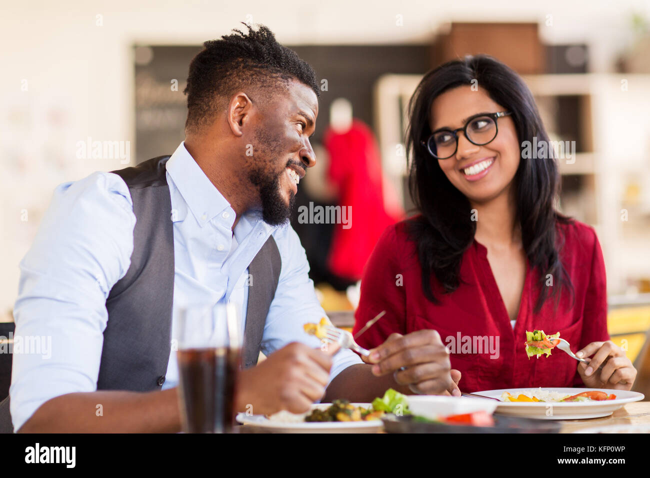 happy couple eating at restaurant Stock Photo - Alamy