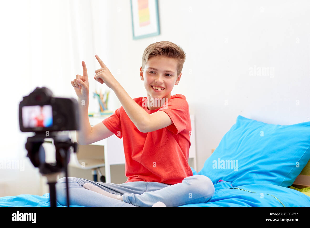 happy boy with camera recording video at home Stock Photo - Alamy