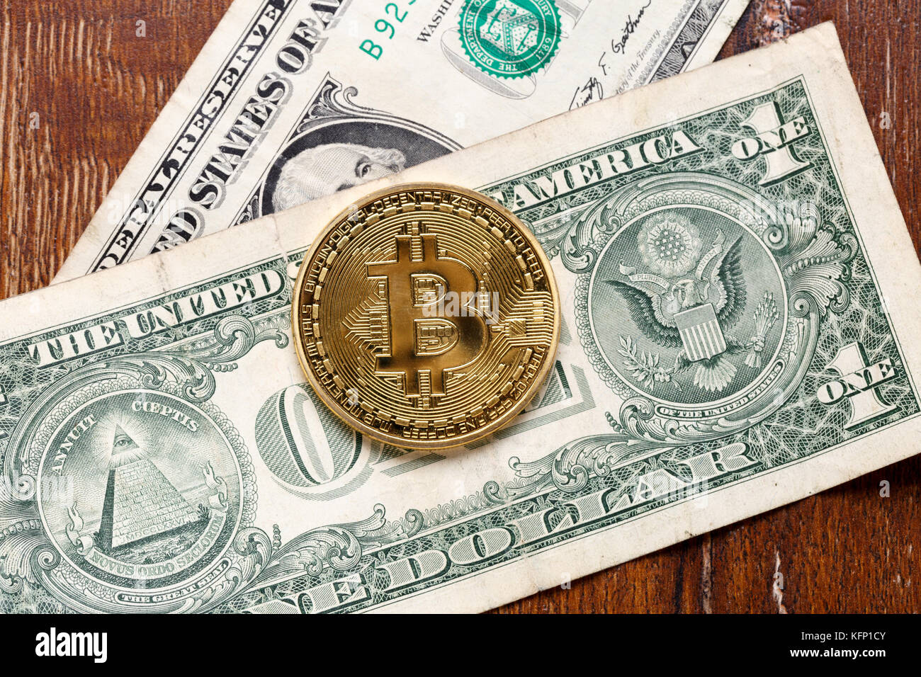 Metal bitcoin coin on one dollar banknote Stock Photo - Alamy