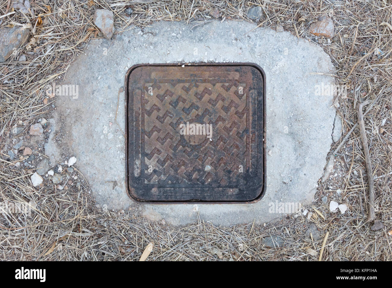 Steel manhole cover or metal sewer on a street in Greece Stock Photo ...