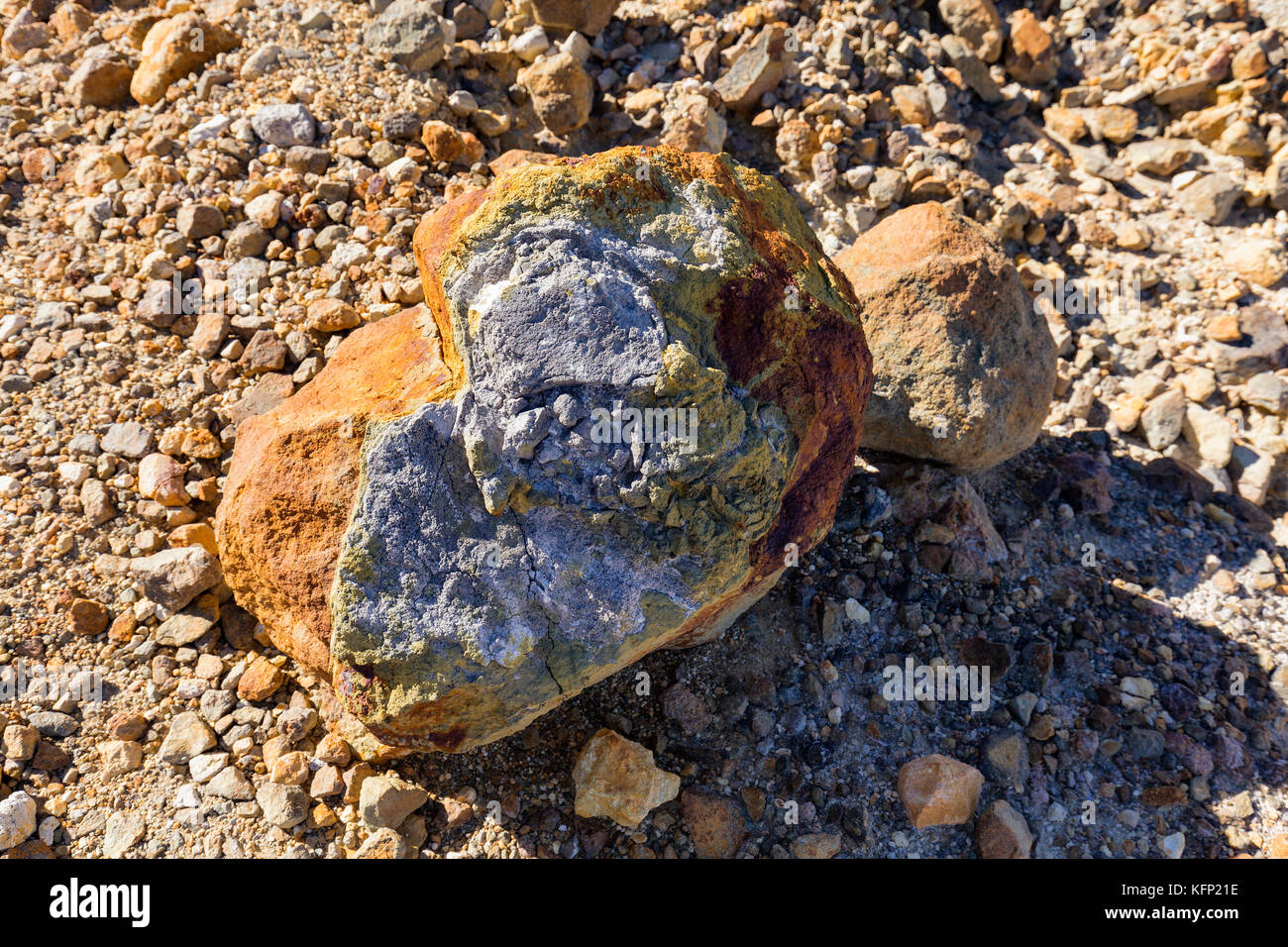 A multi-colored rock at the summit of mount Egon, an active volcano on ...
