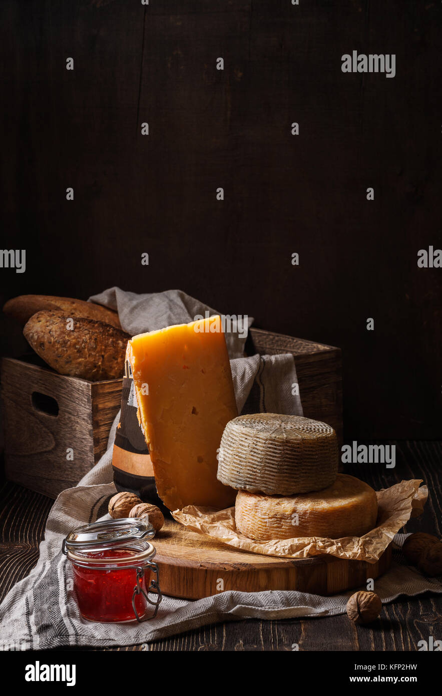 Dark still life with cheese and bread Stock Photo - Alamy