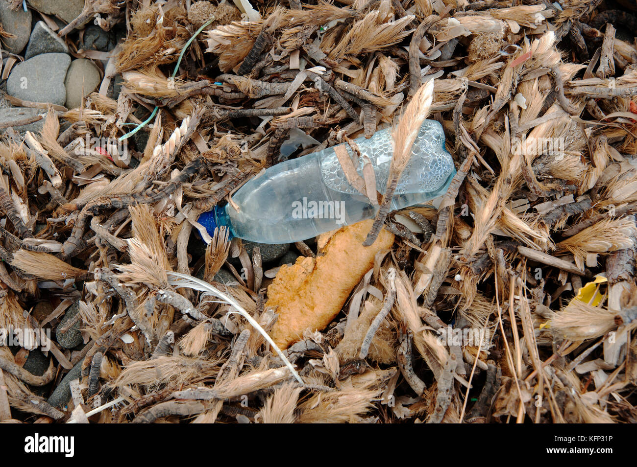 Washed up plastic bottle on a beach on the island of Menorca in the ...