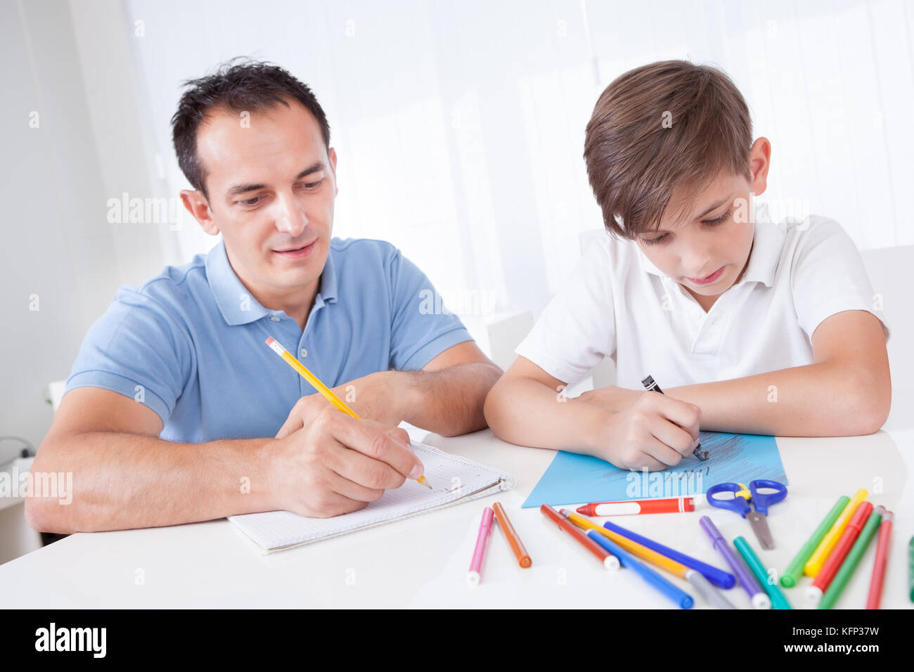 Father And Son Drawing Together With Colorful Pencils And Crayons At ...