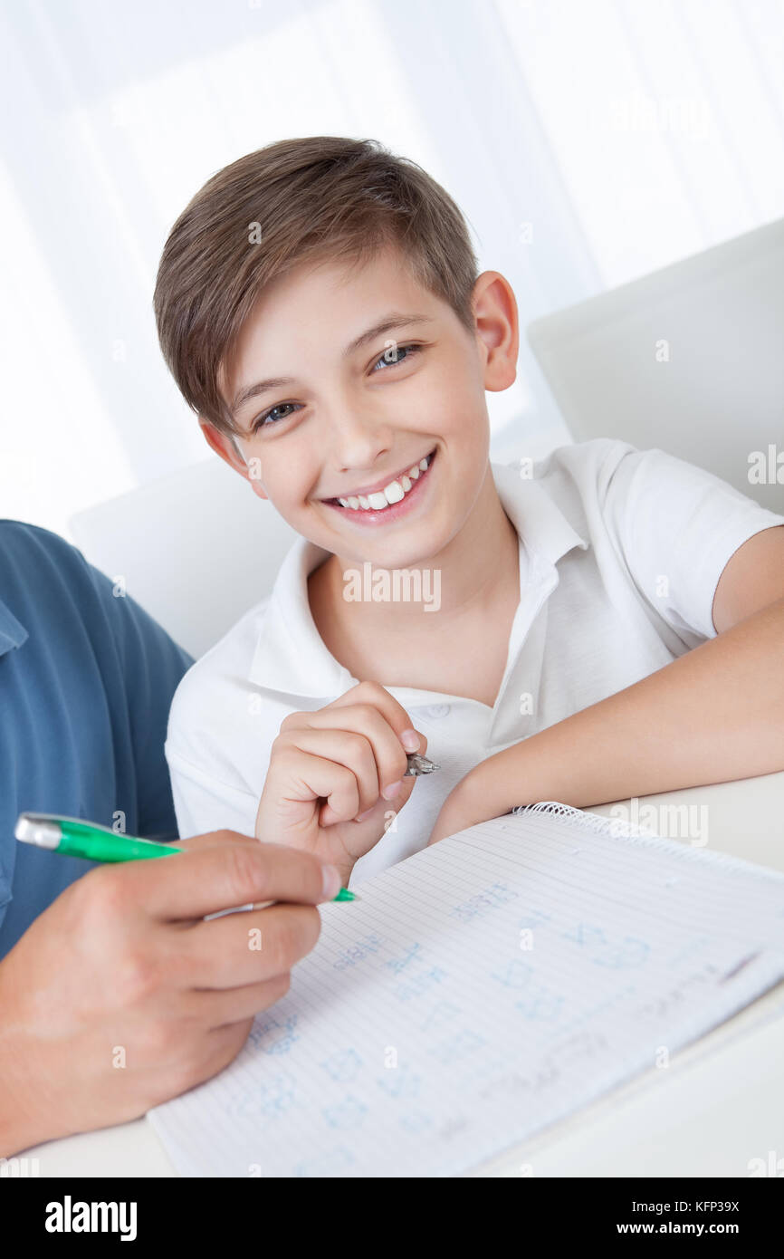 Portrait Of Son Doing Homework At Home Stock Photo - Alamy