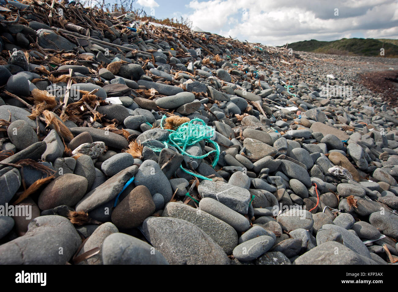 Washed up plastic flotsam and jetsam litter a beach on the island of ...