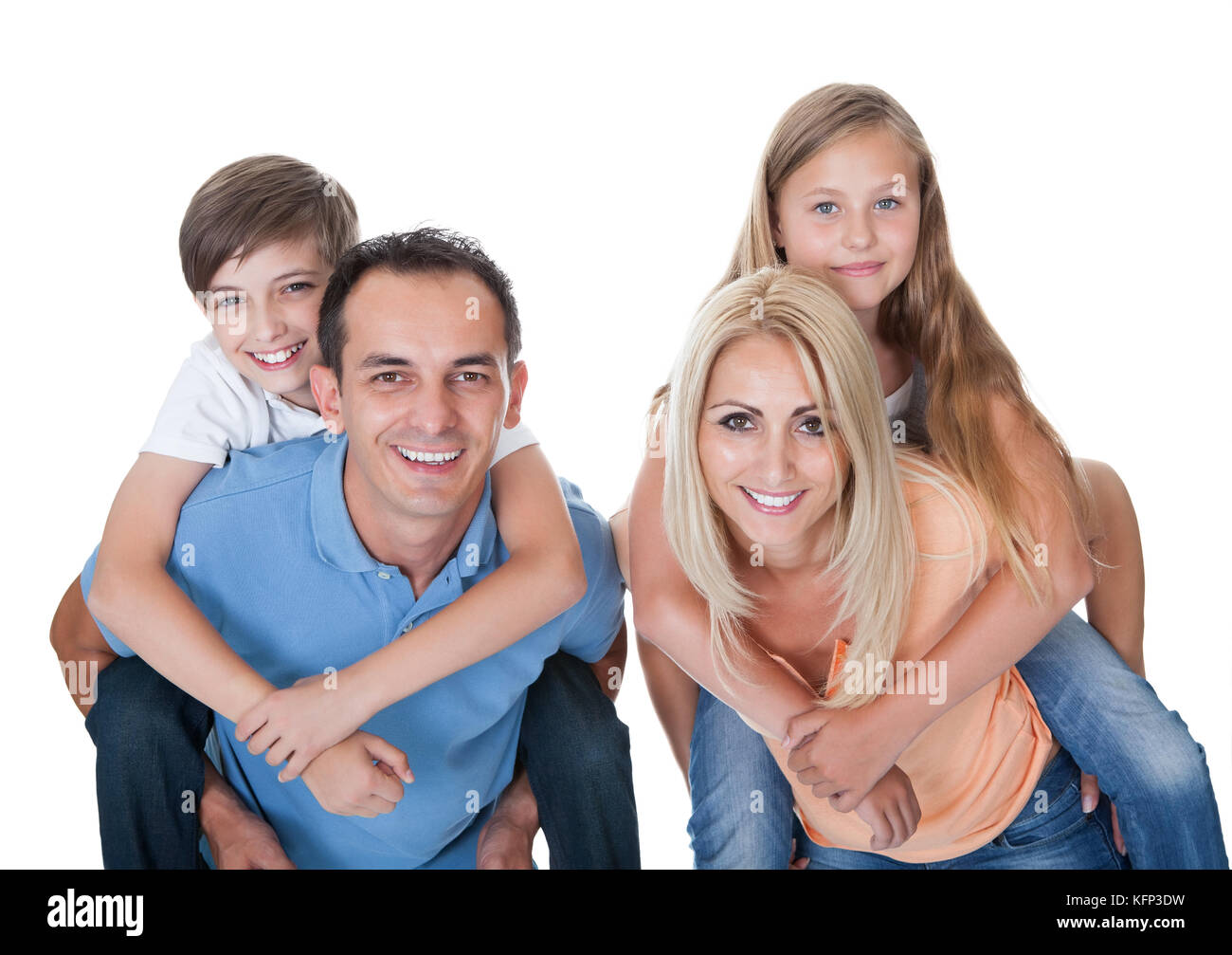 Couple Giving Two Young Children Piggyback Rides Isolated On White ...