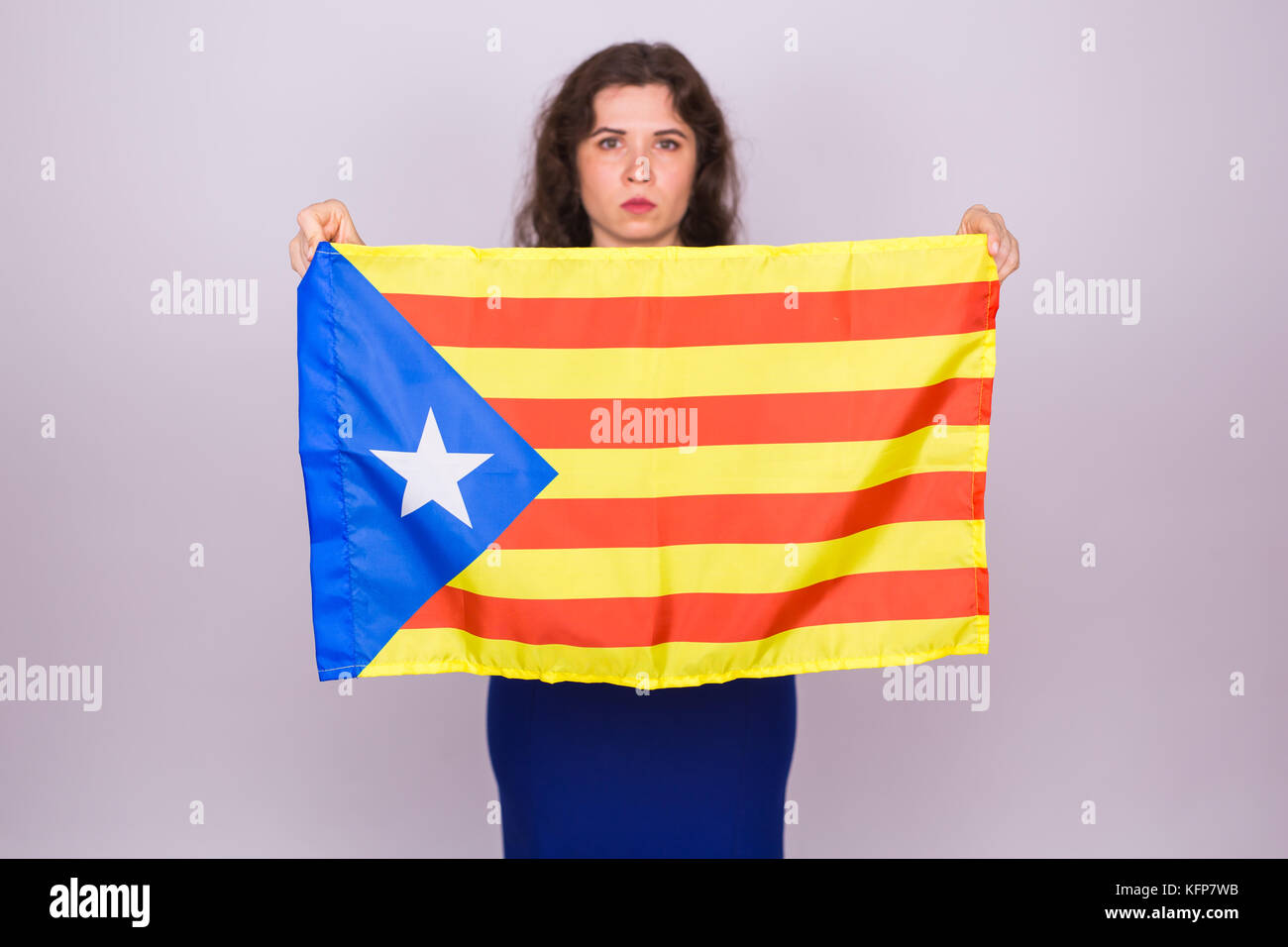 Portrait Of A serious catalan woman with estelada flag. Referendum For ...