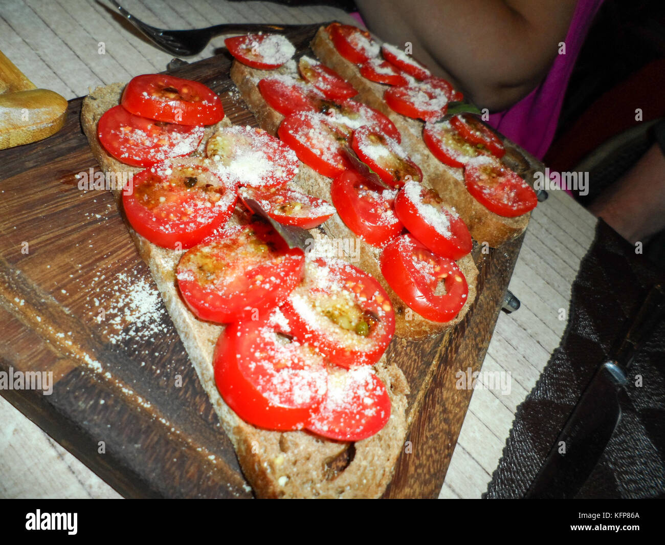 Turkish restaurant dish of toasted village bread with tomatoes, basil ...