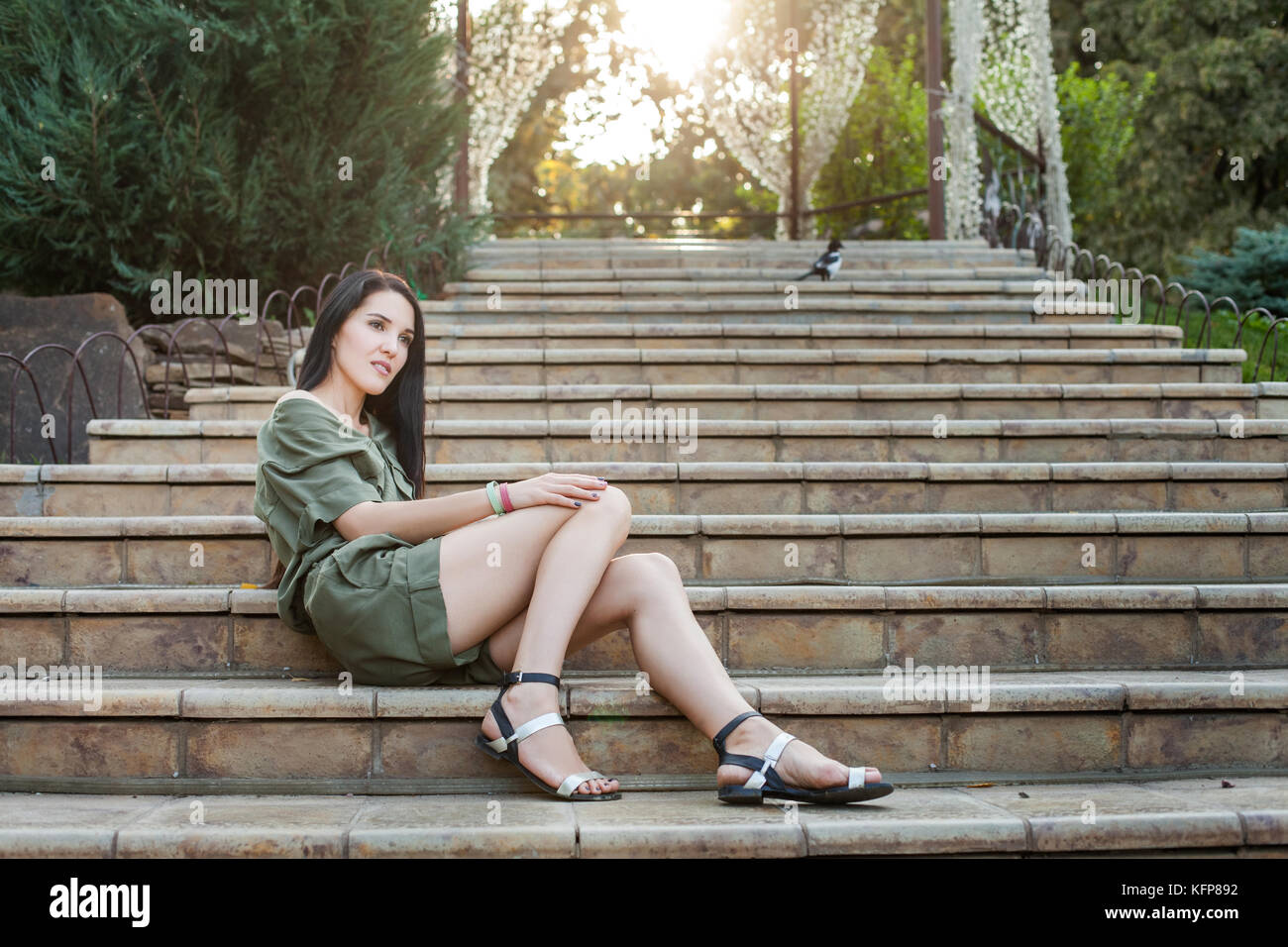 girl sitting on stone steps Stock Photo - Alamy