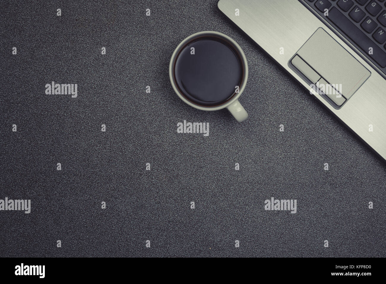 Laptop computer or notebook and a cup of coffee on gray color modern ...