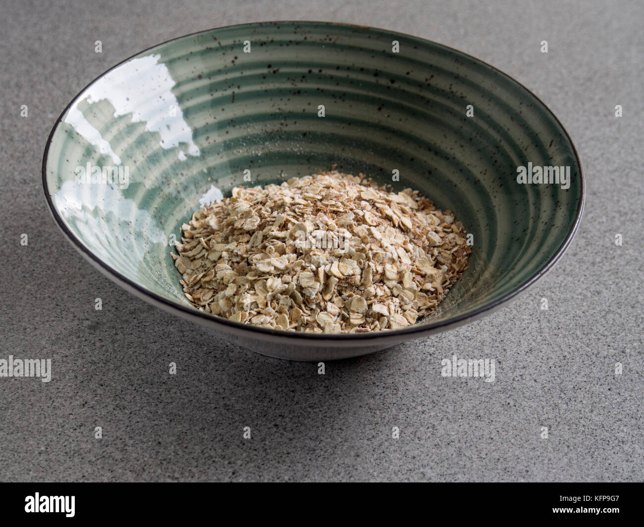 Bowl with oatmill on grey background Stock Photo - Alamy