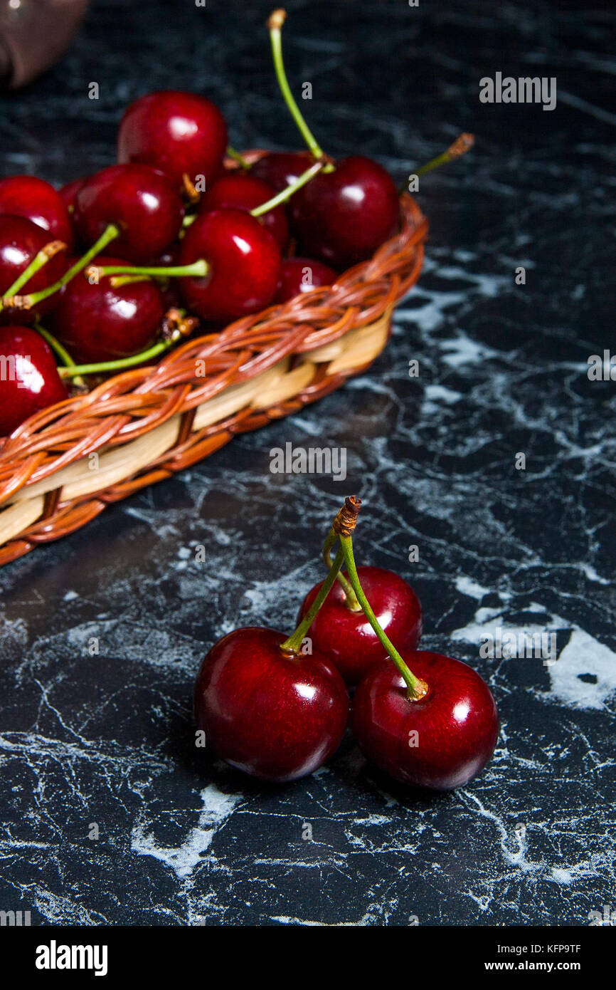 Close up view of several red sweet cherries on the marble table and ...