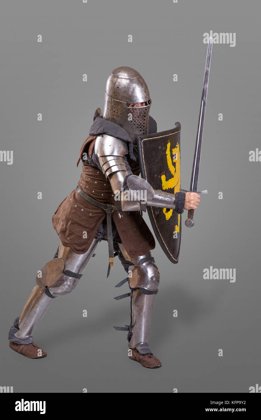 knight in breaths in a helmet with a sword and shield in battle ...