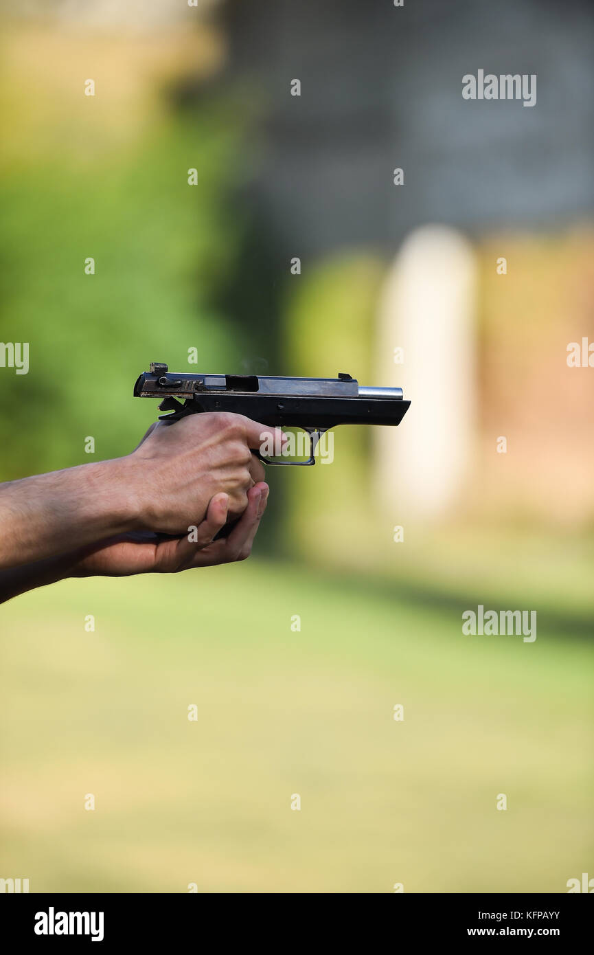 Outdoor shooting with a 9mm pistol in a shooting range Stock Photo - Alamy