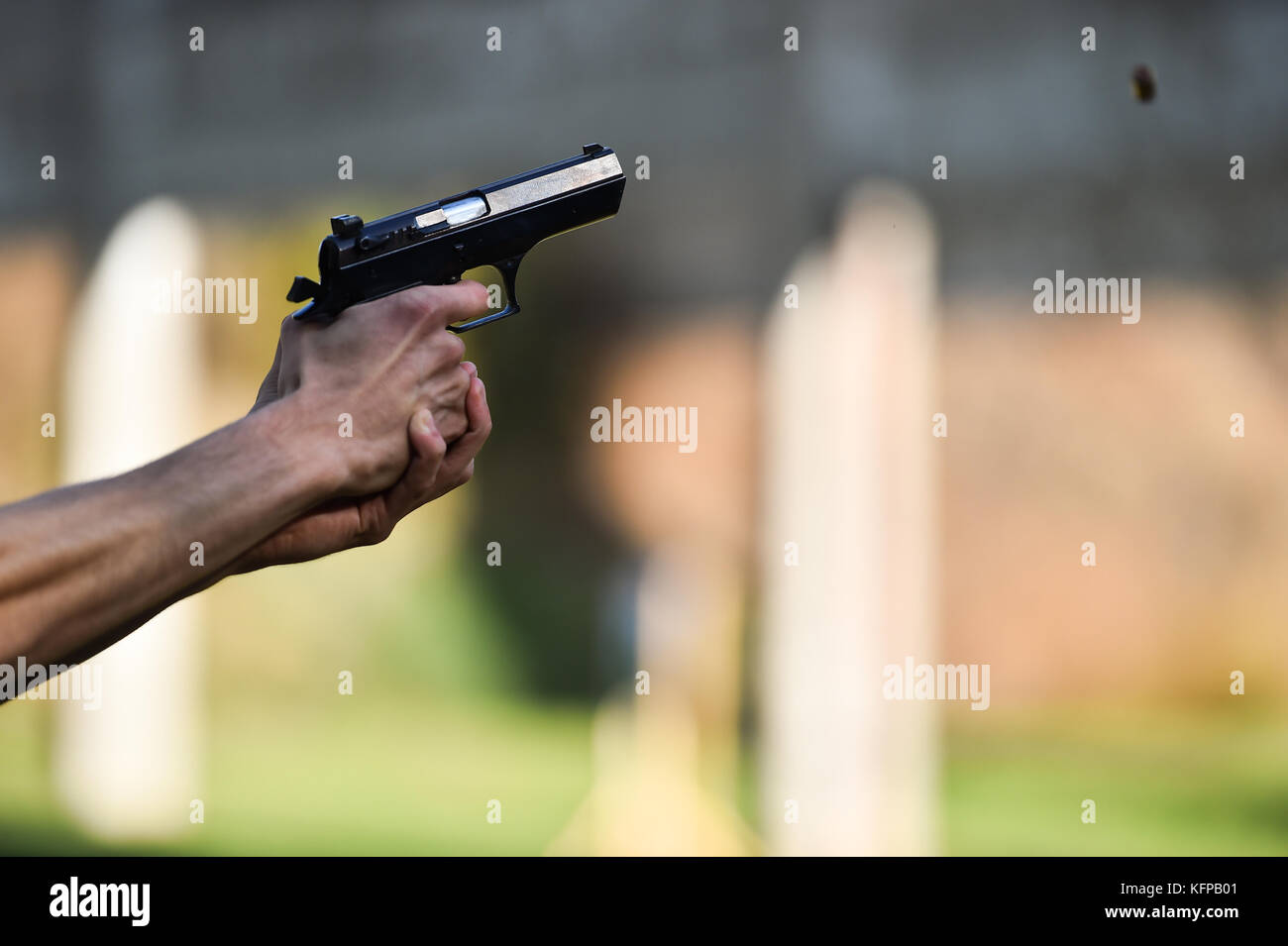 Outdoor shooting with a 9mm pistol in a shooting range Stock Photo - Alamy