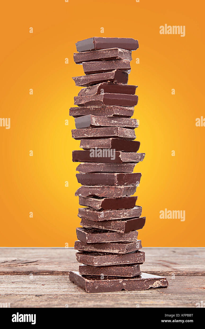 Stack of chocolate pieces on shiny backdrop Stock Photo - Alamy