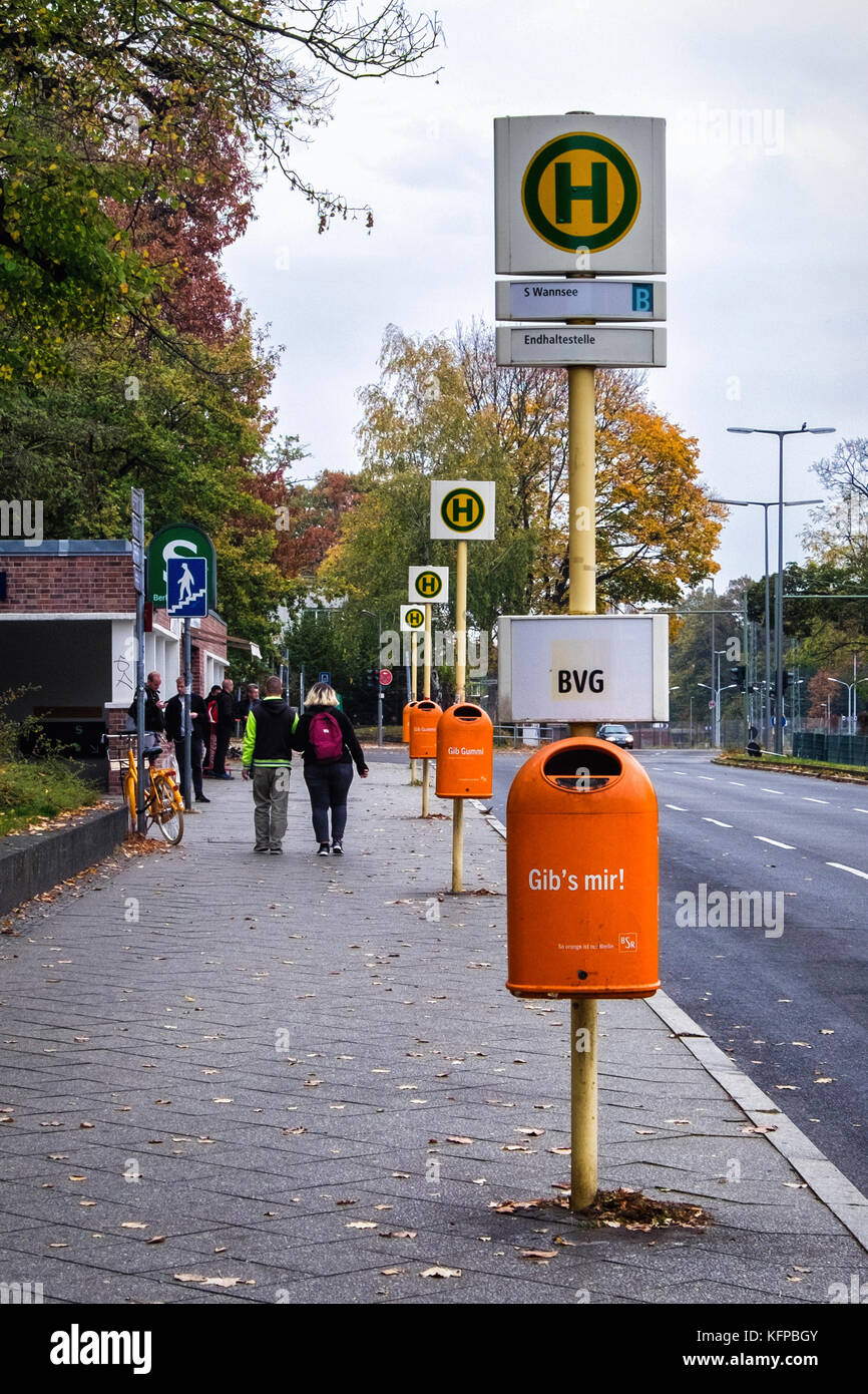 Berlin Wannsee,Row of BVG Bus stop signs and orange rubbish bins in ...