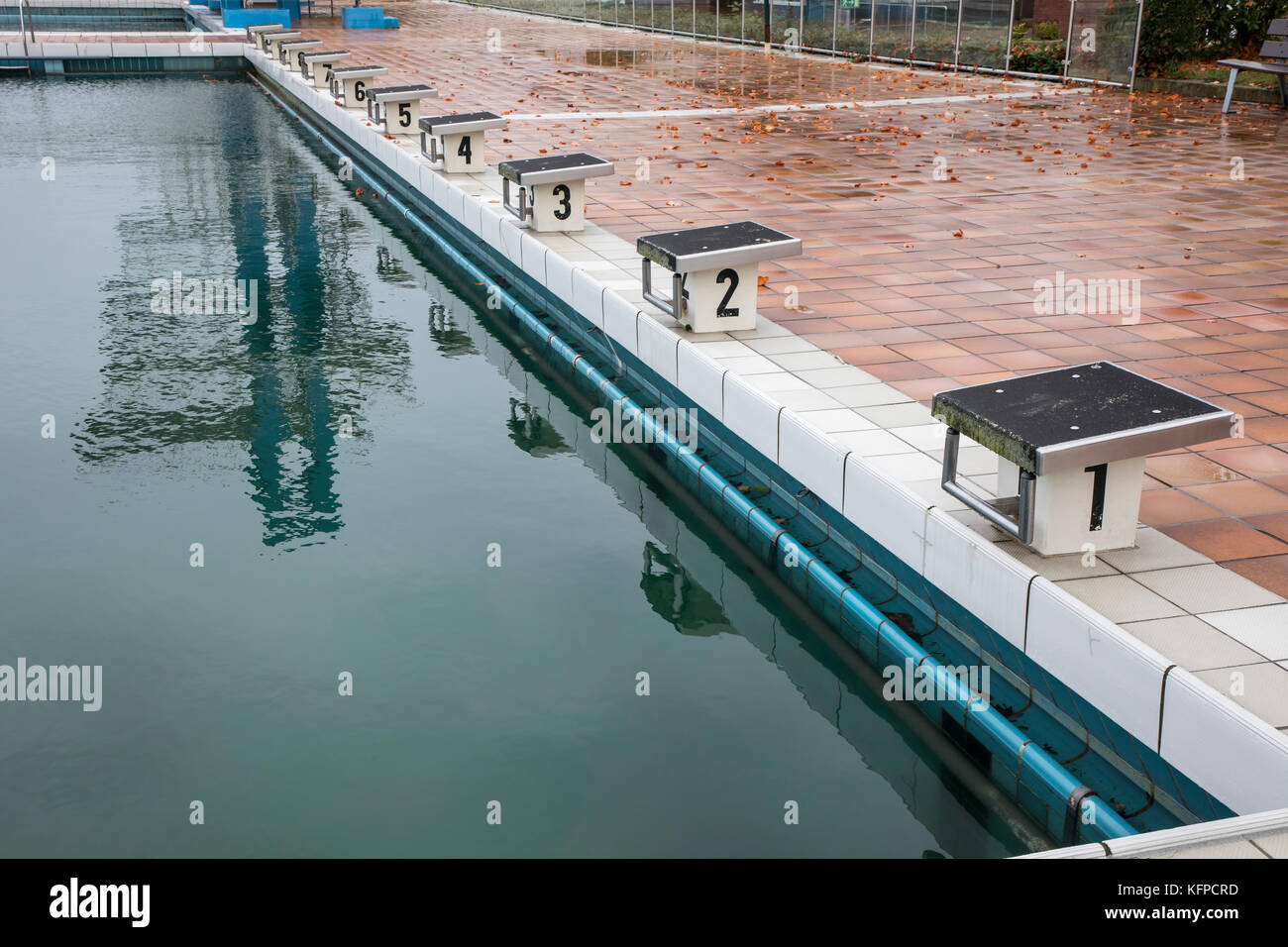 Public swimming pool, closed for the season, in fall, starting block ...