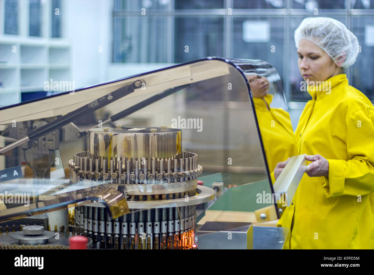 Pharmaceutical worker wearing protective work wear. Female worker ...