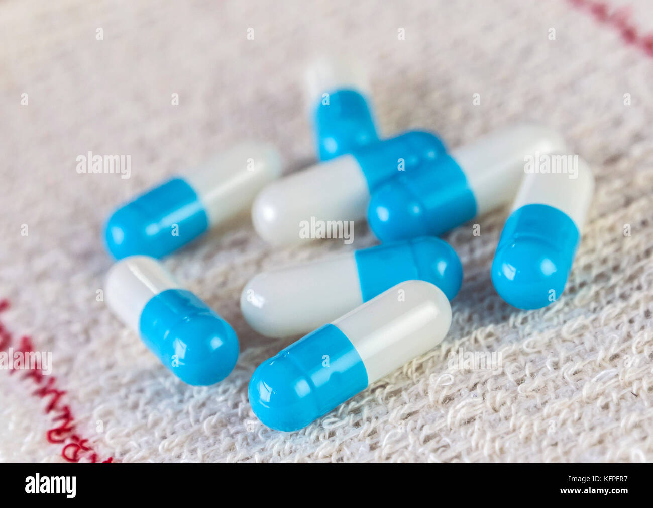 Some blue Pills Wrapped In Gauze Stock Photo - Alamy
