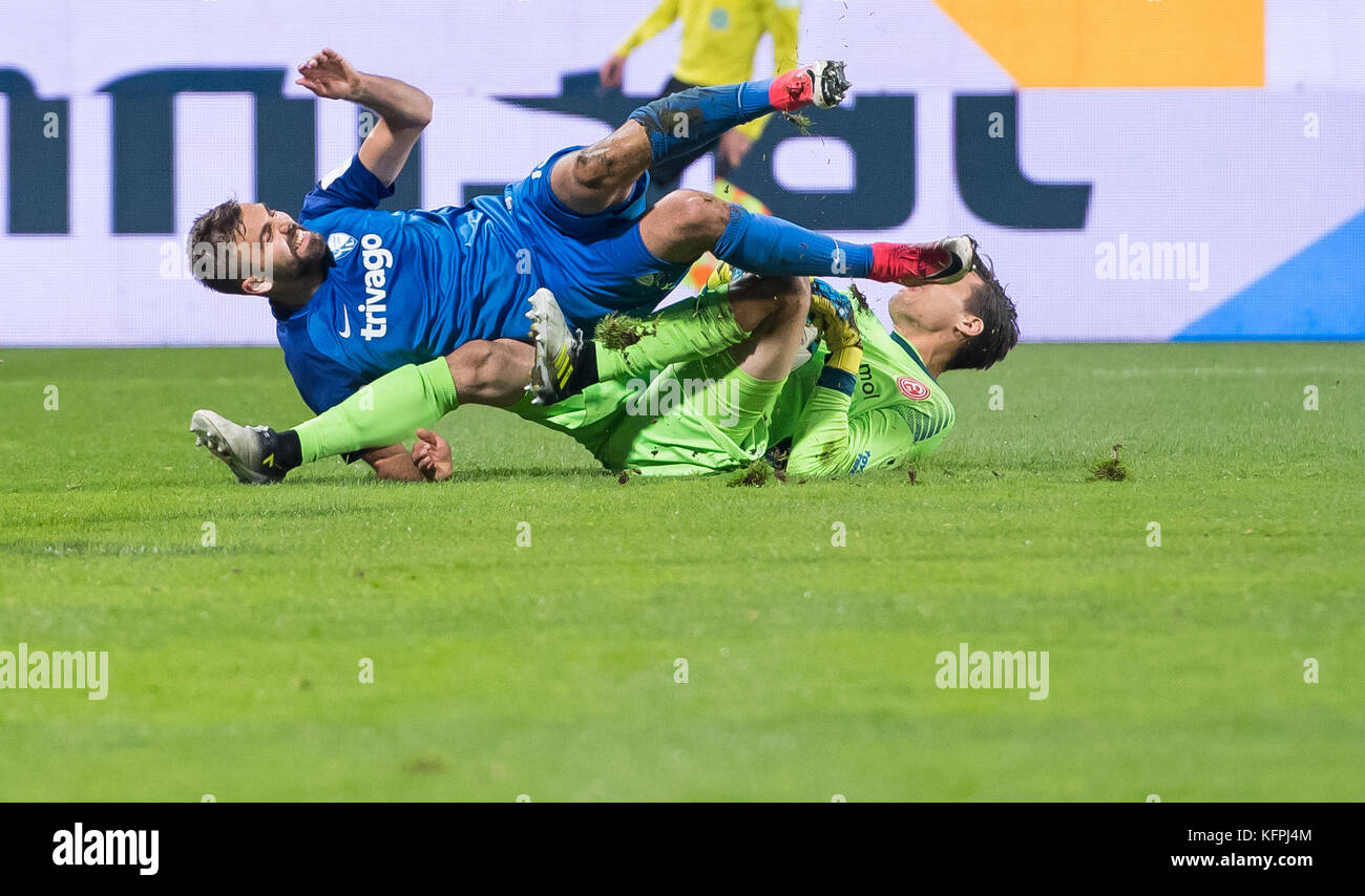 Bochum's Lukas Hinterseer (L) fouls Duesseldorf's goalkeeper Raphael ...