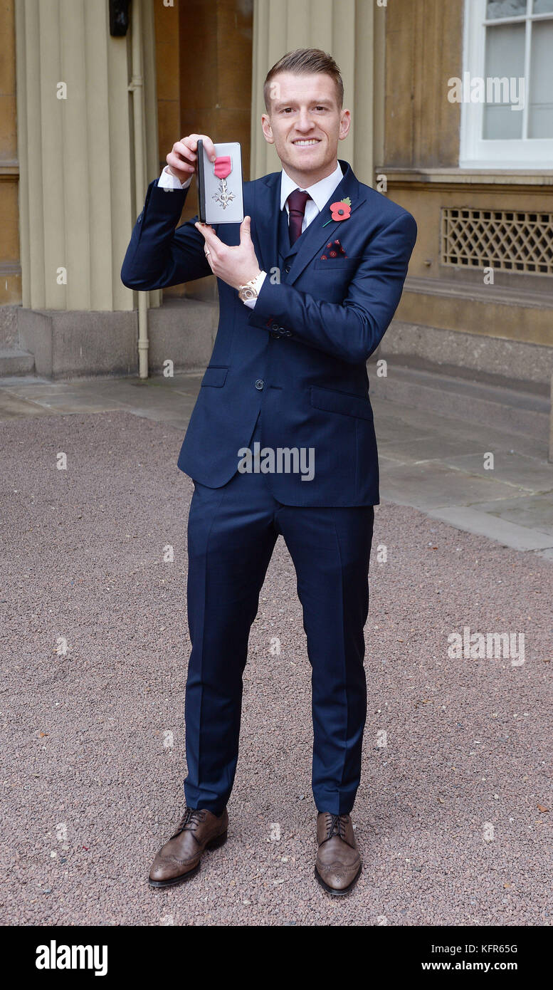 Footballer Steven Davis holds the MBE presented to him by the Duke of ...