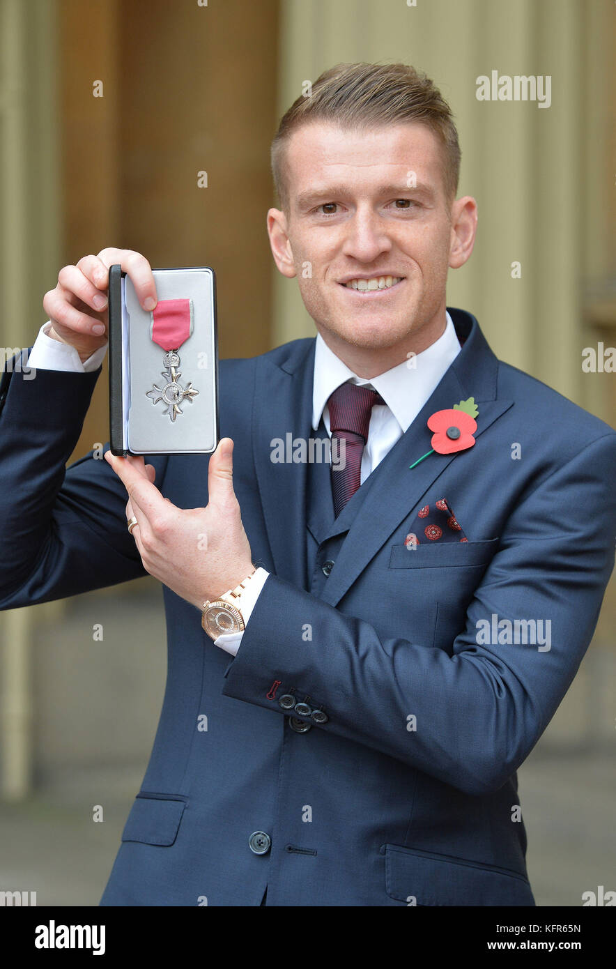 Footballer Steven Davis holds the MBE presented to him by the Duke of ...