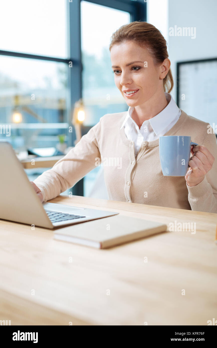 Smiling office manager dedicated to work Stock Photo - Alamy