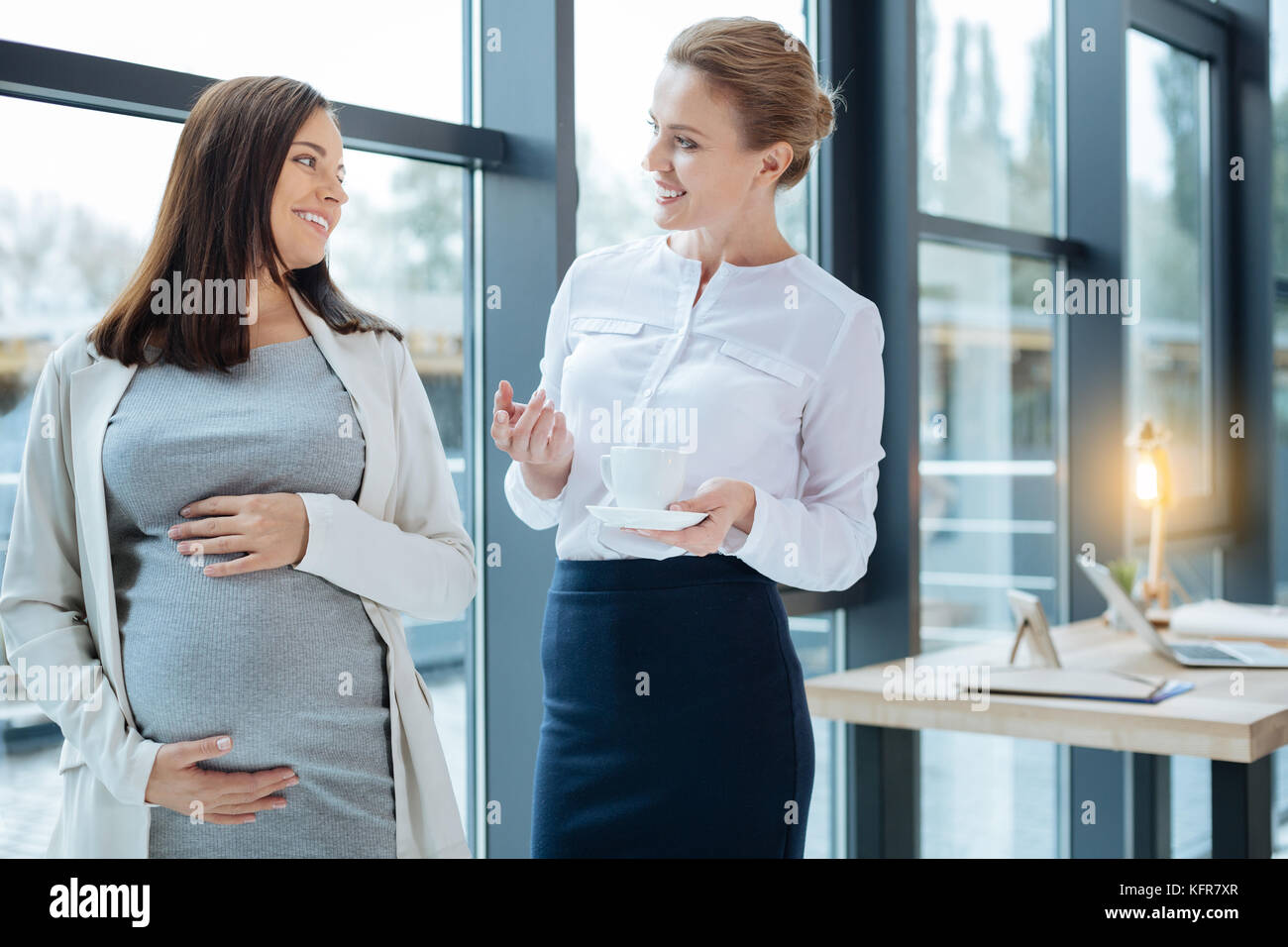 Optimistic colleagues having exciting talk Stock Photo - Alamy
