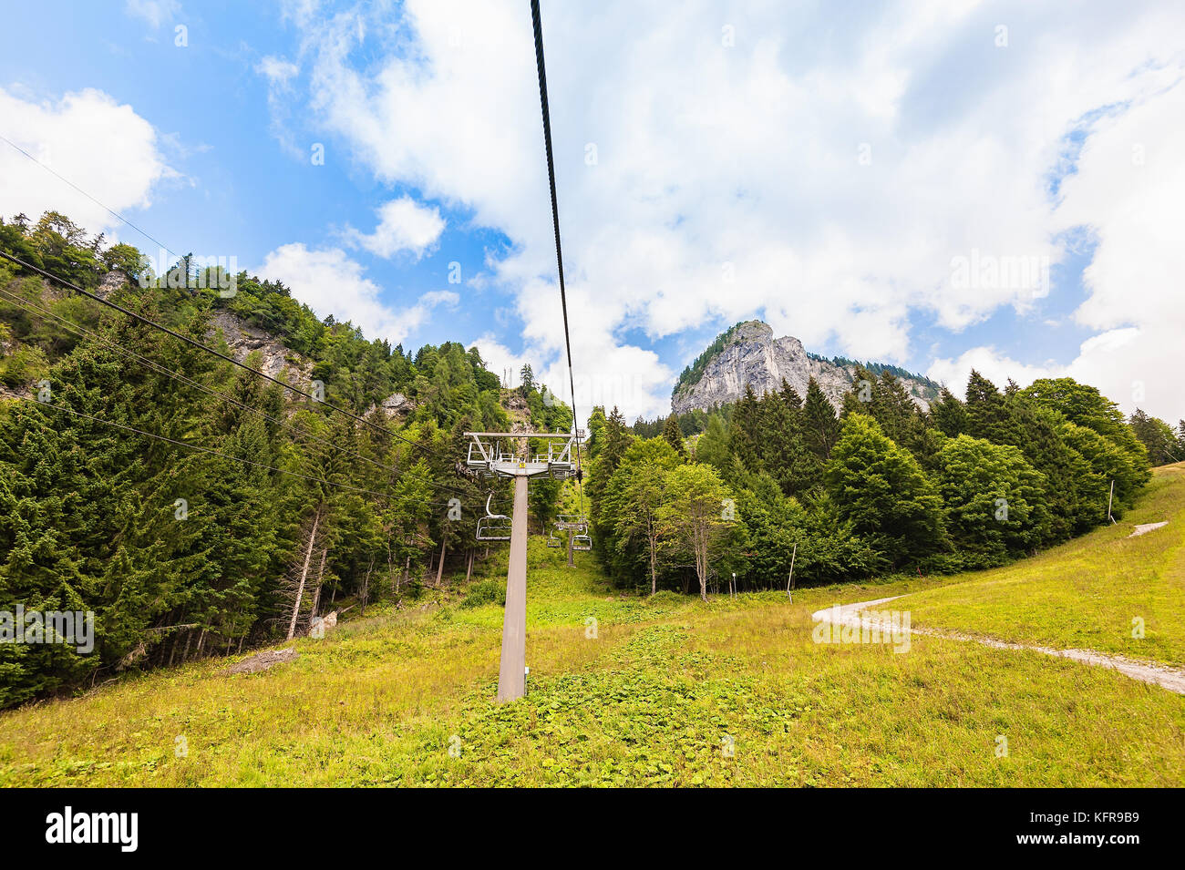 Chairlift ski lift in European Alps. Transporting hikers in summer ...