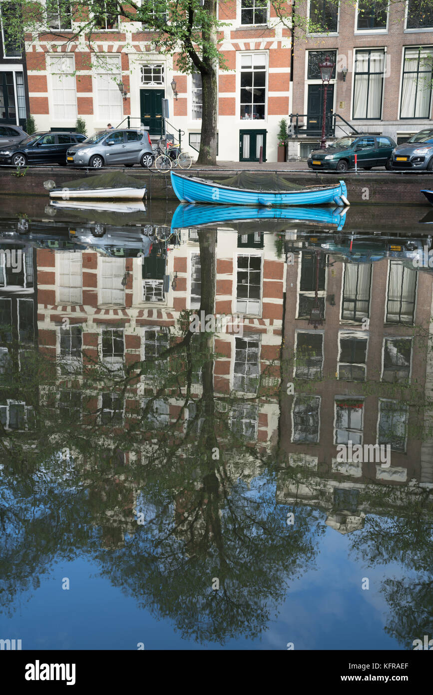 Reflection and blue boat in canals in Amsterdam Netherlands Stock Photo ...