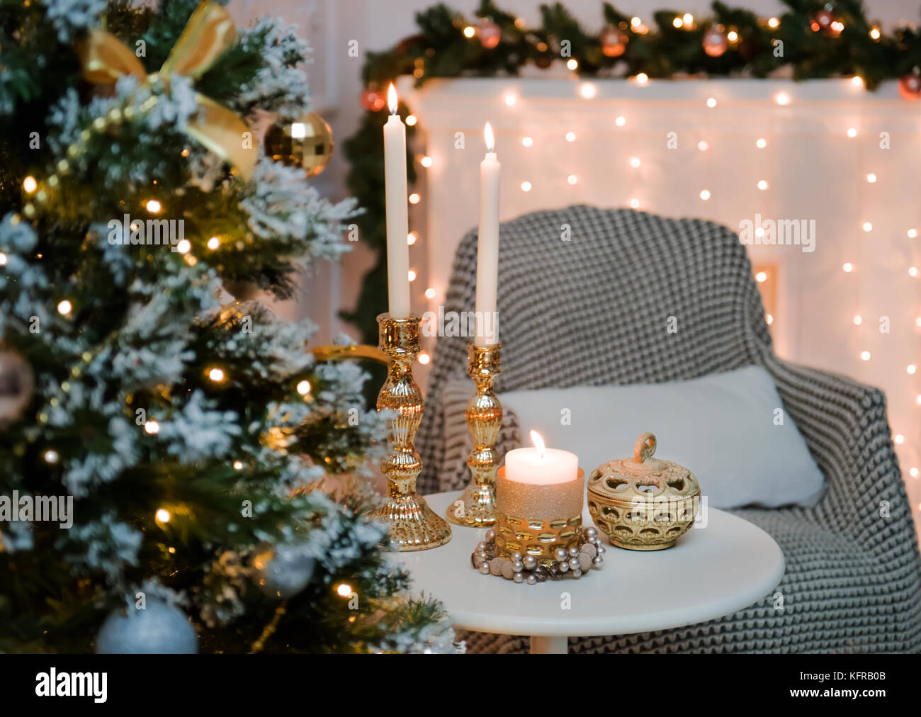 New Year's candles and a Christmas tree in the lights Stock Photo - Alamy