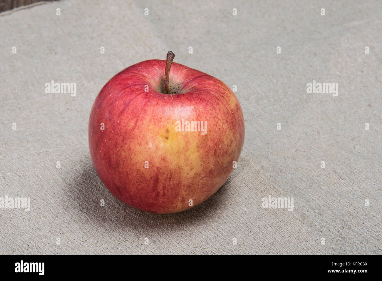 Ripe apple on sackcloth. One red apple Stock Photo - Alamy