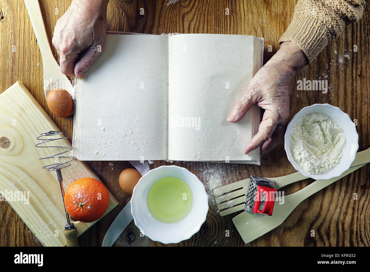 Open recipe book in the hands of an elderly woman Stock Photo - Alamy