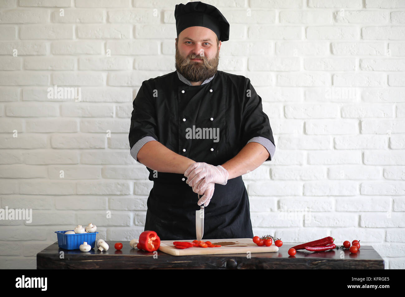Bearded chef chef prepares meals Stock Photo - Alamy