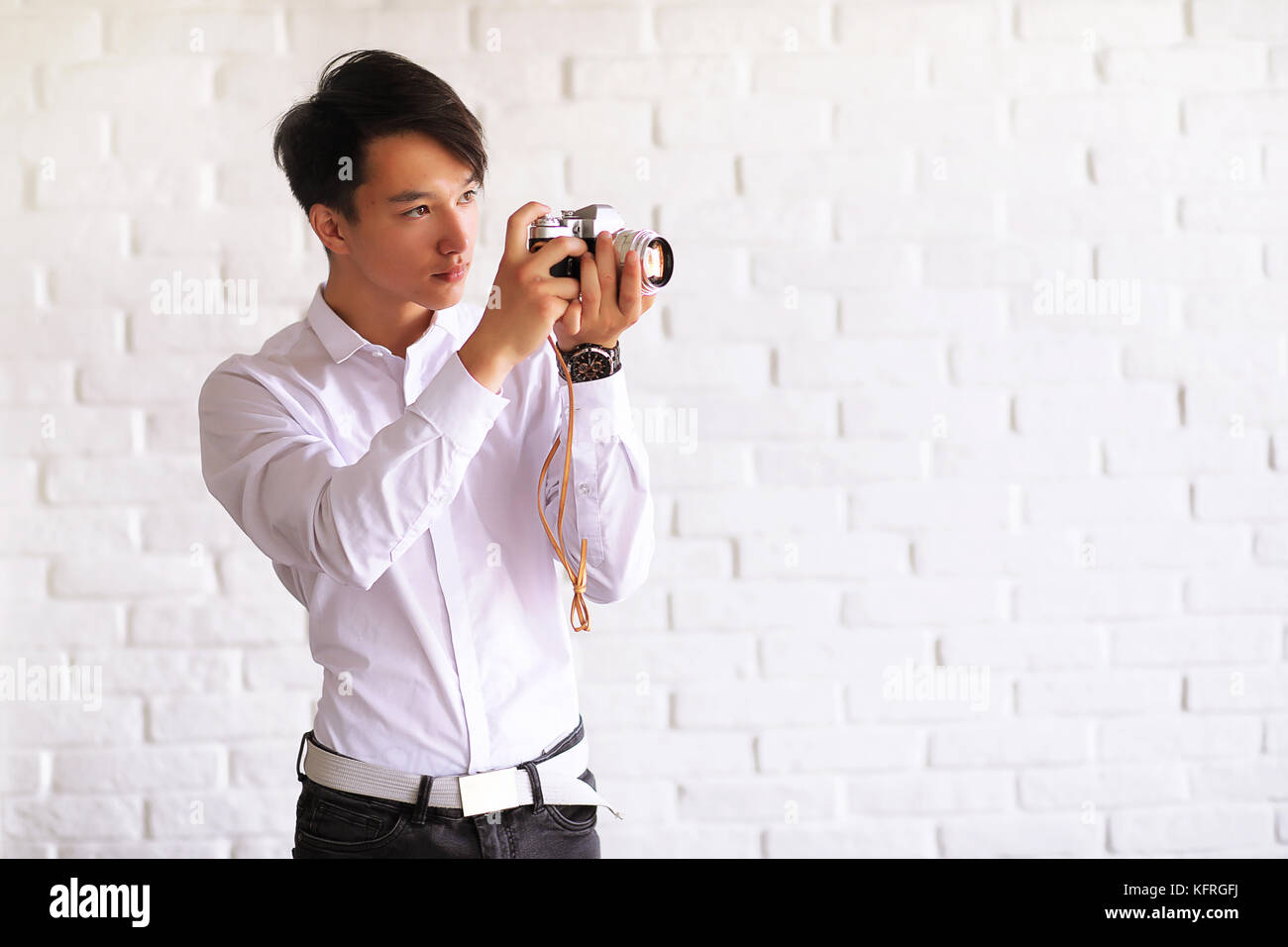 Asian young man with a camera Stock Photo - Alamy