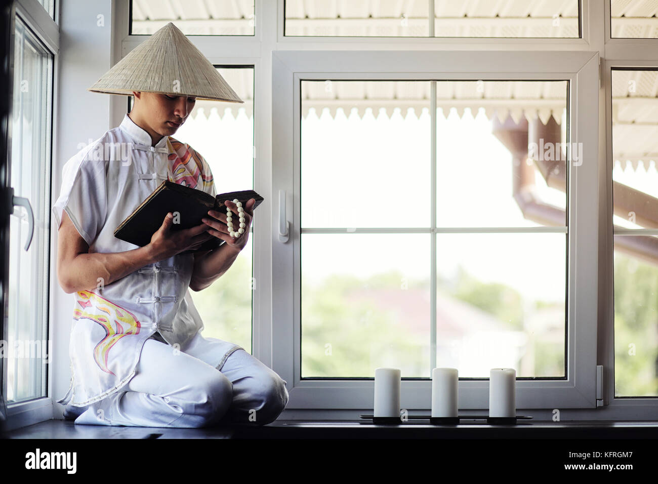 Asian monk reading an old book Stock Photo - Alamy
