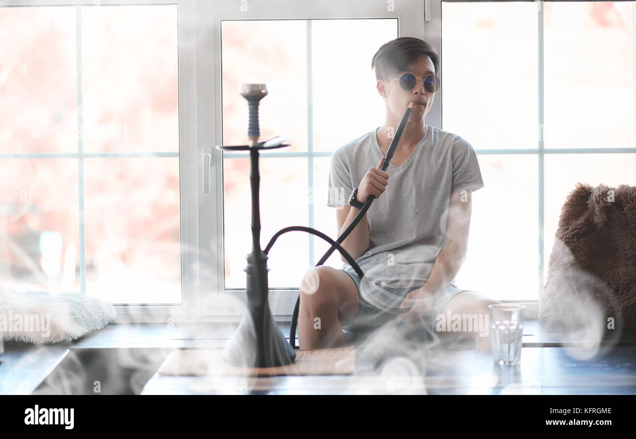 Man in sunglasses smoking a hookah Stock Photo - Alamy