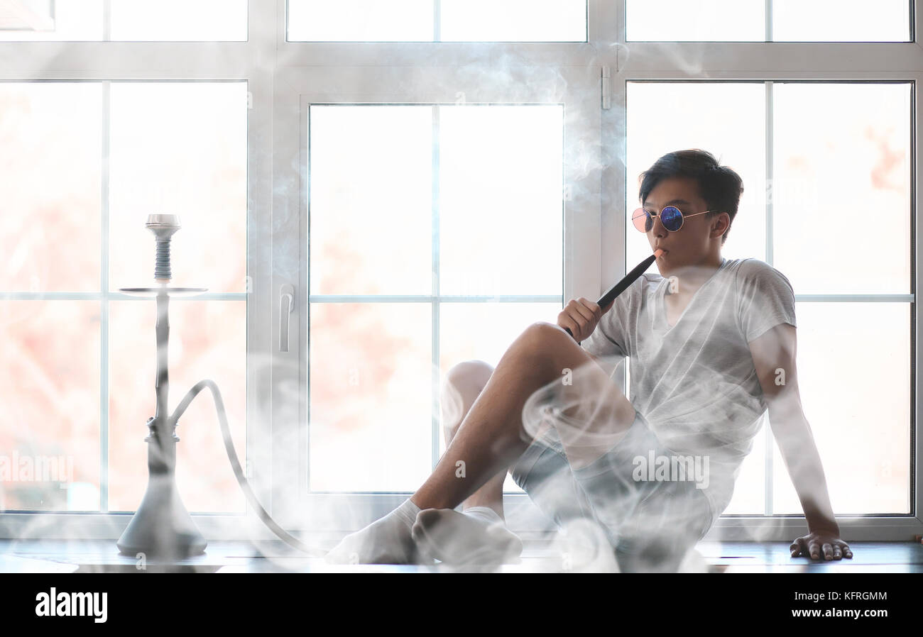 Man in sunglasses smoking a hookah Stock Photo - Alamy