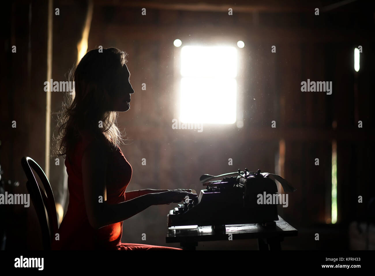 A girl in retro style prints on an old typewriter Stock Photo - Alamy