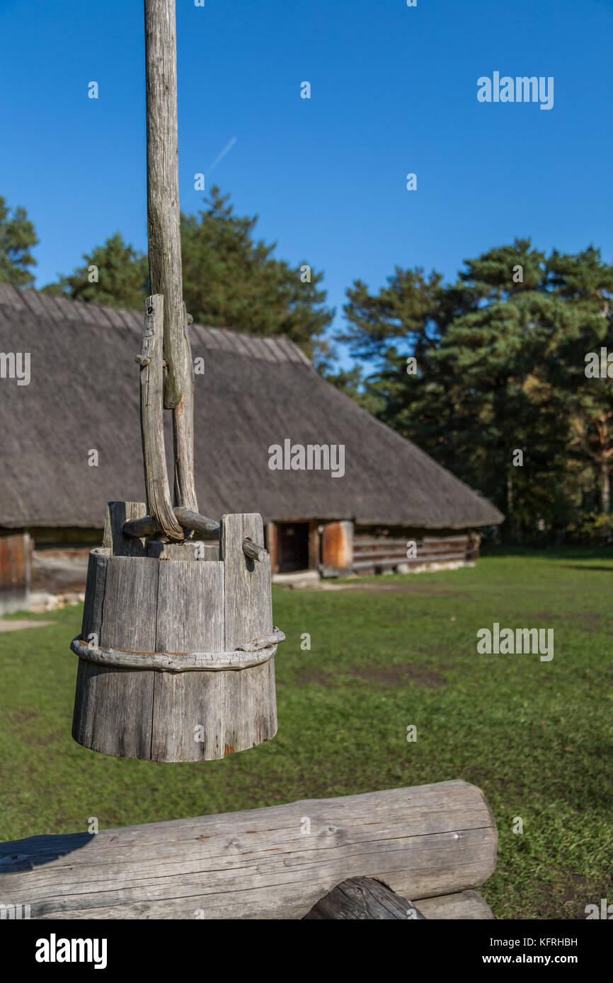 Traditional ancient wooden country hut and well Stock Photo - Alamy