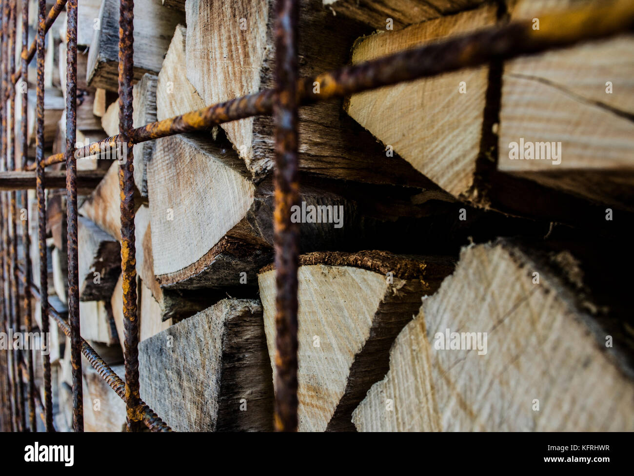 Imprisoned wood shows fireplace wood in a rusty metal cage Stock Photo ...